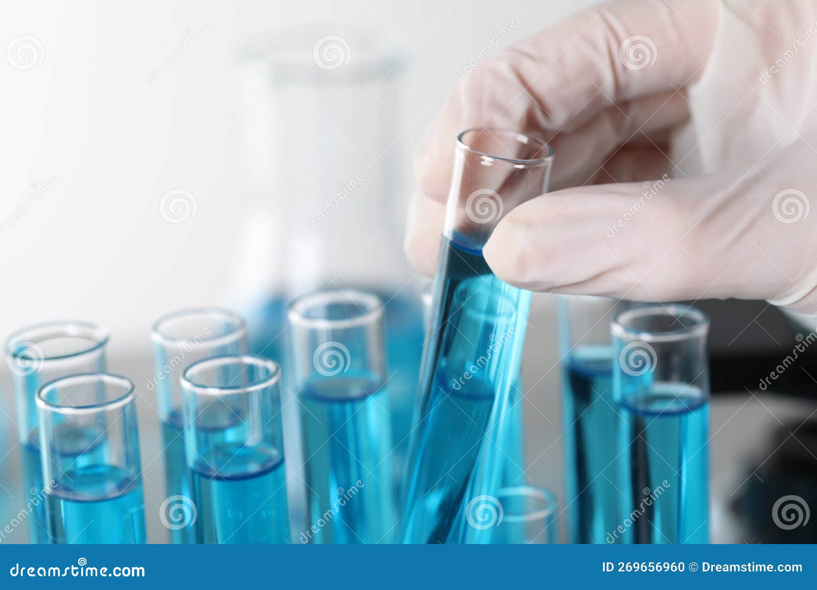 Scientist Taking Test Tube with Light Blue Liquid in Laboratory ...
