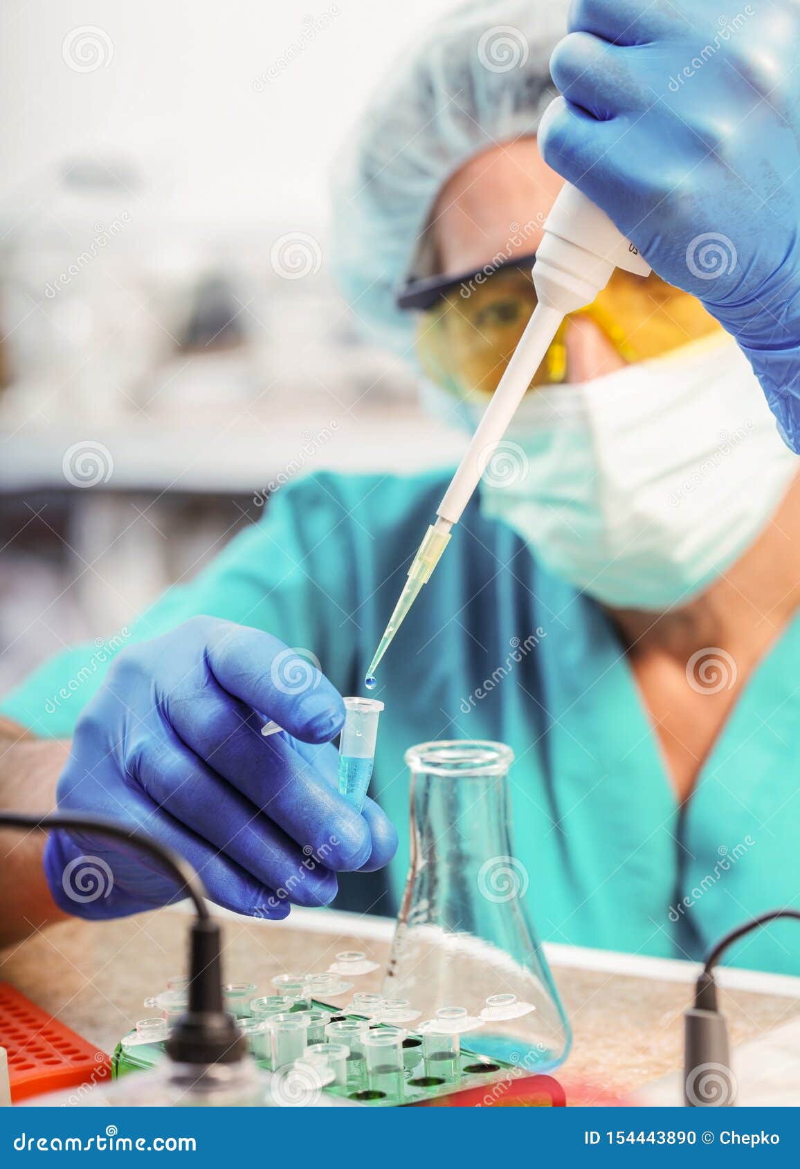 Scientist with Test Tubes and Flasks Conducting an Experiment in a ...