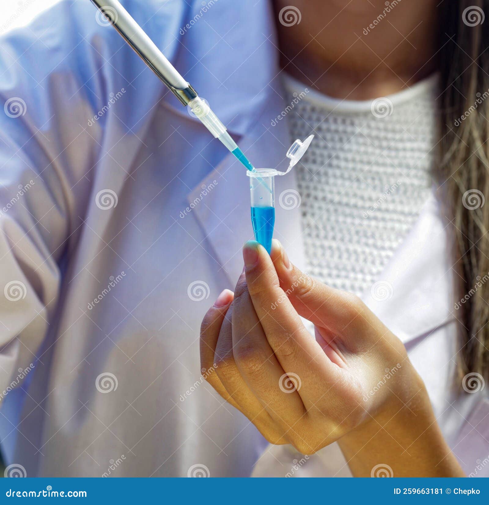 Scientist with Test Tubes and Flasks Conducting an Experiment in a ...
