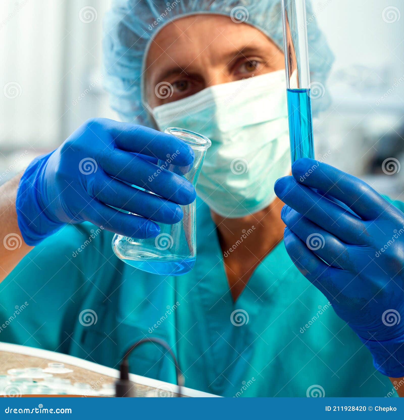 Scientist with Test Tubes and Flasks Conducting an Experiment in a ...