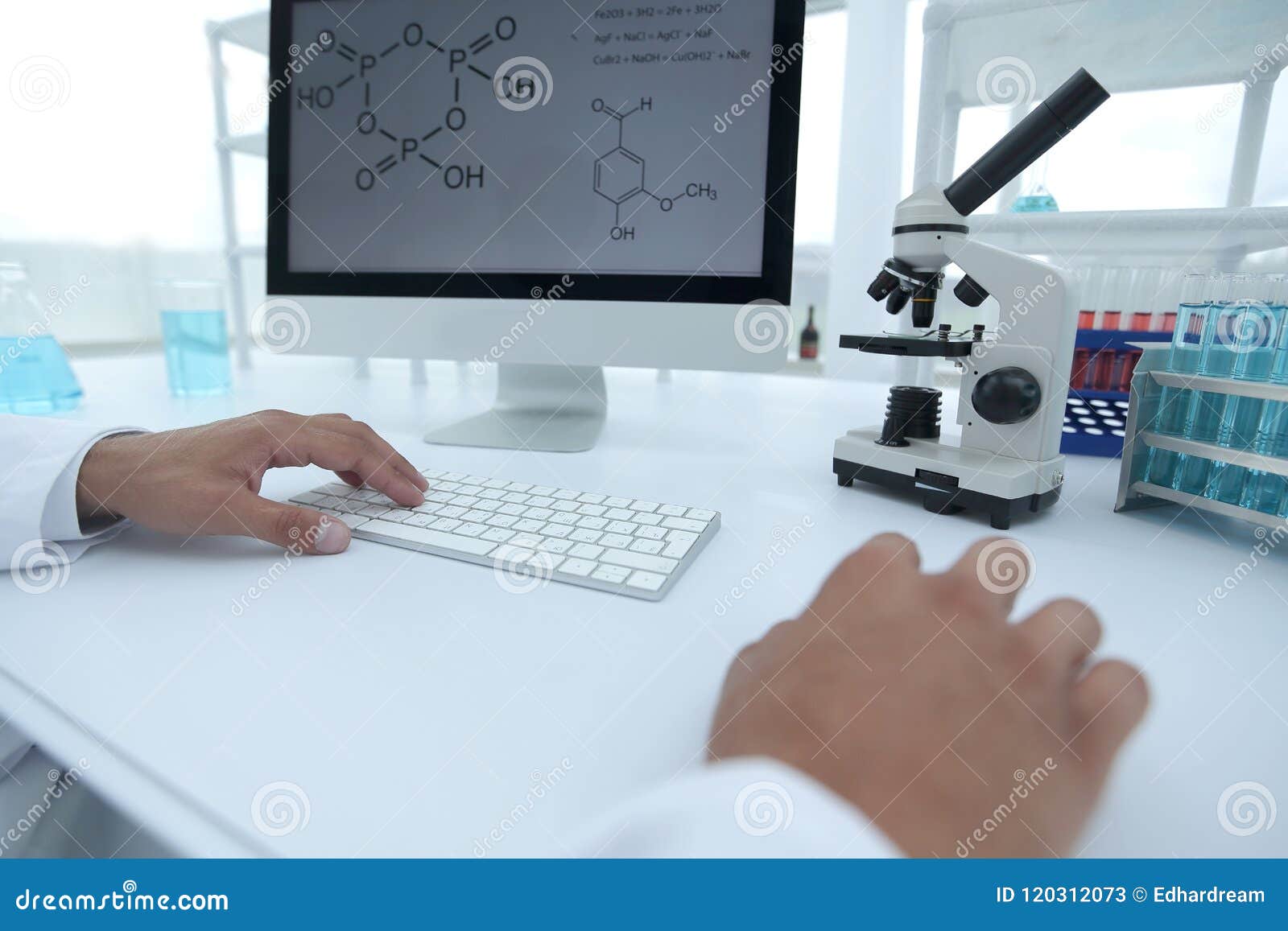 A Scientist Uses a Computer and a Microscope Stock Image - Image of ...