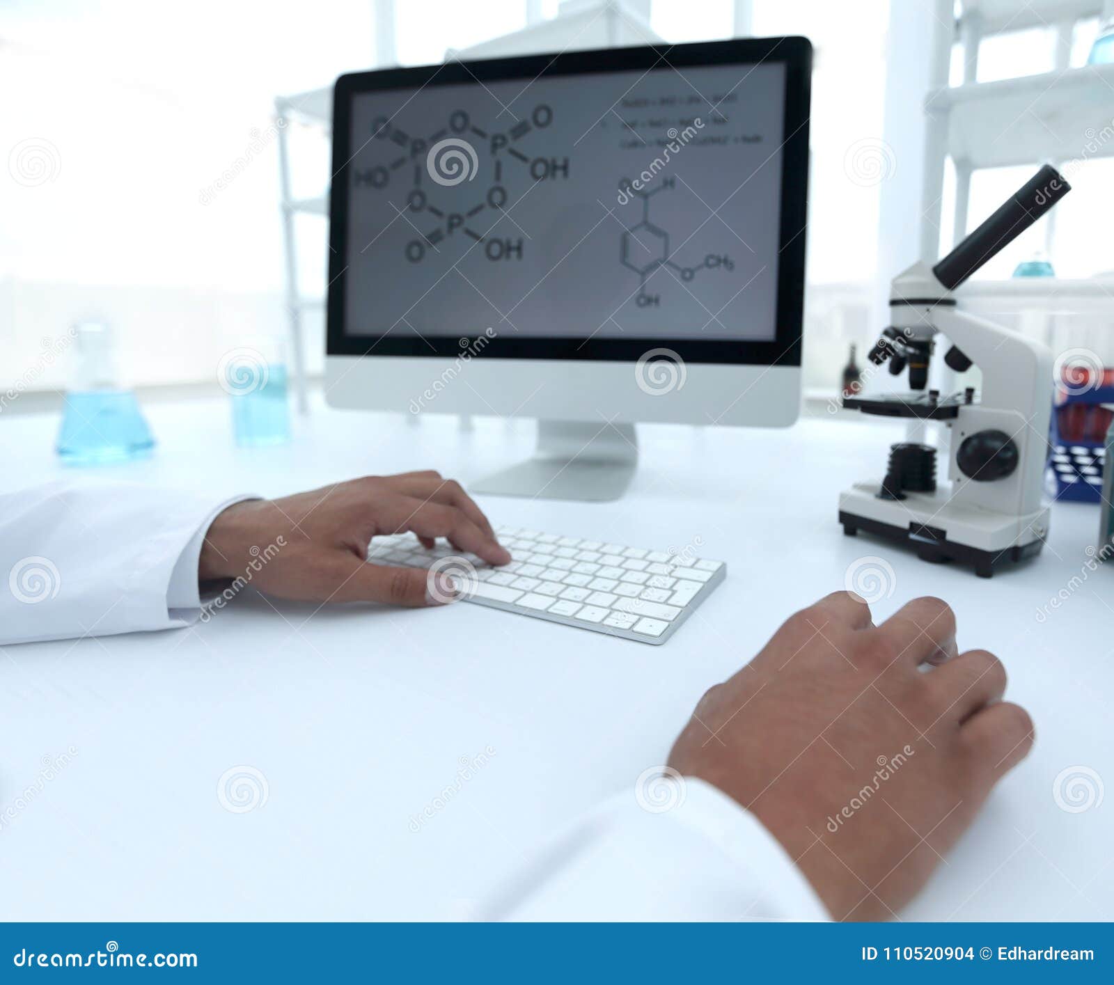 A Scientist Uses a Computer and a Microscope Stock Photo - Image of ...