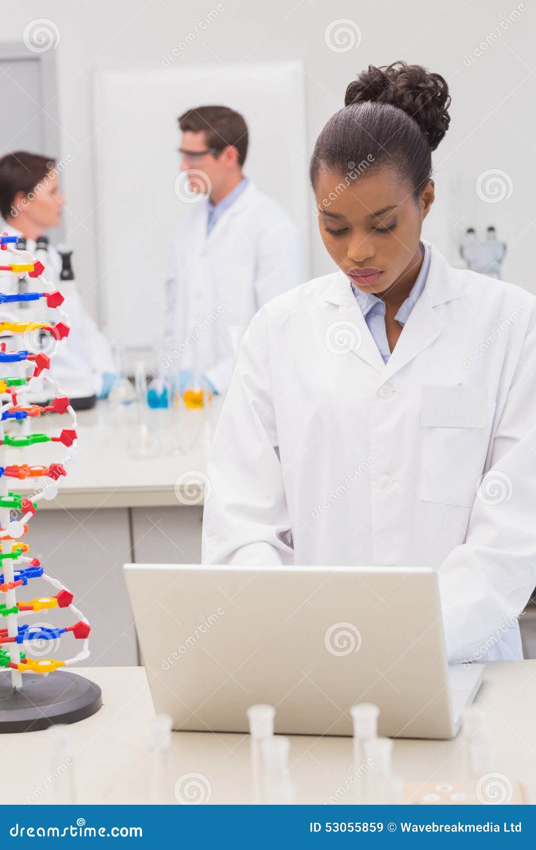 Scientist Using Laptop while Colleagues Talking Together Stock Image ...