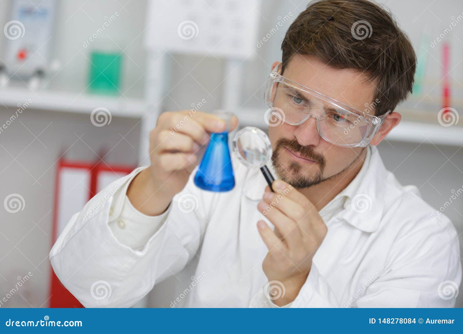 Scientist Using Magnifying Glass in Test Tube Stock Photo - Image of ...