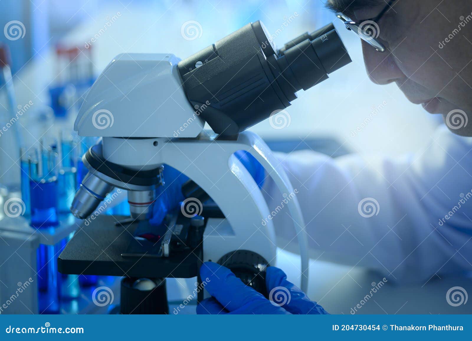 Scientist Using Microscope during Experiment in Laboratory, Science and ...
