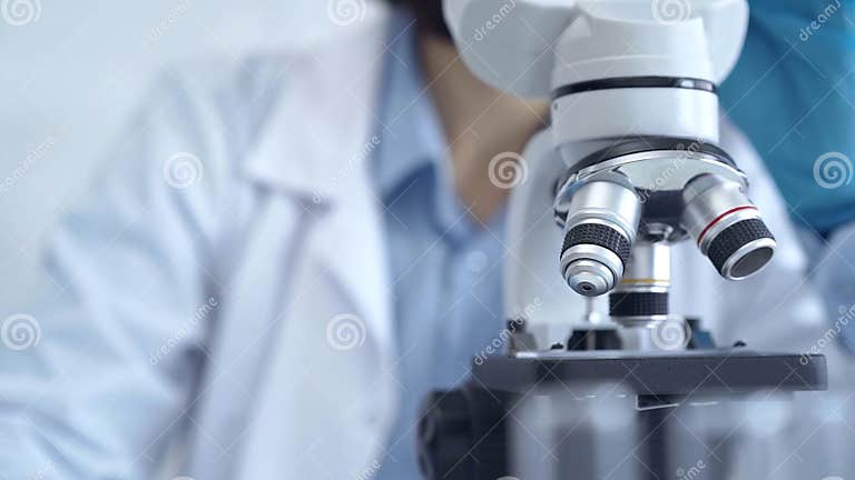 Scientist Using Microscope in Laboratory. Close-up of a Researcher S ...