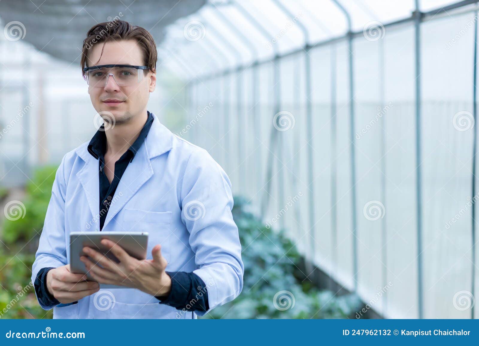 Scientist Using Tablet. Scientist Work at Vegetable Garden Lab Site ...