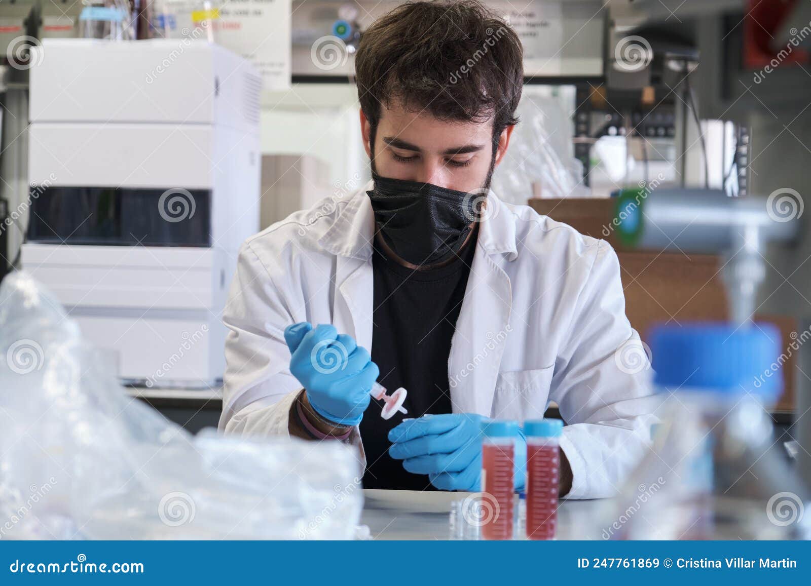 Scientist in White Lab Coat and Face Mask Filter Sample into HPLC Vial ...
