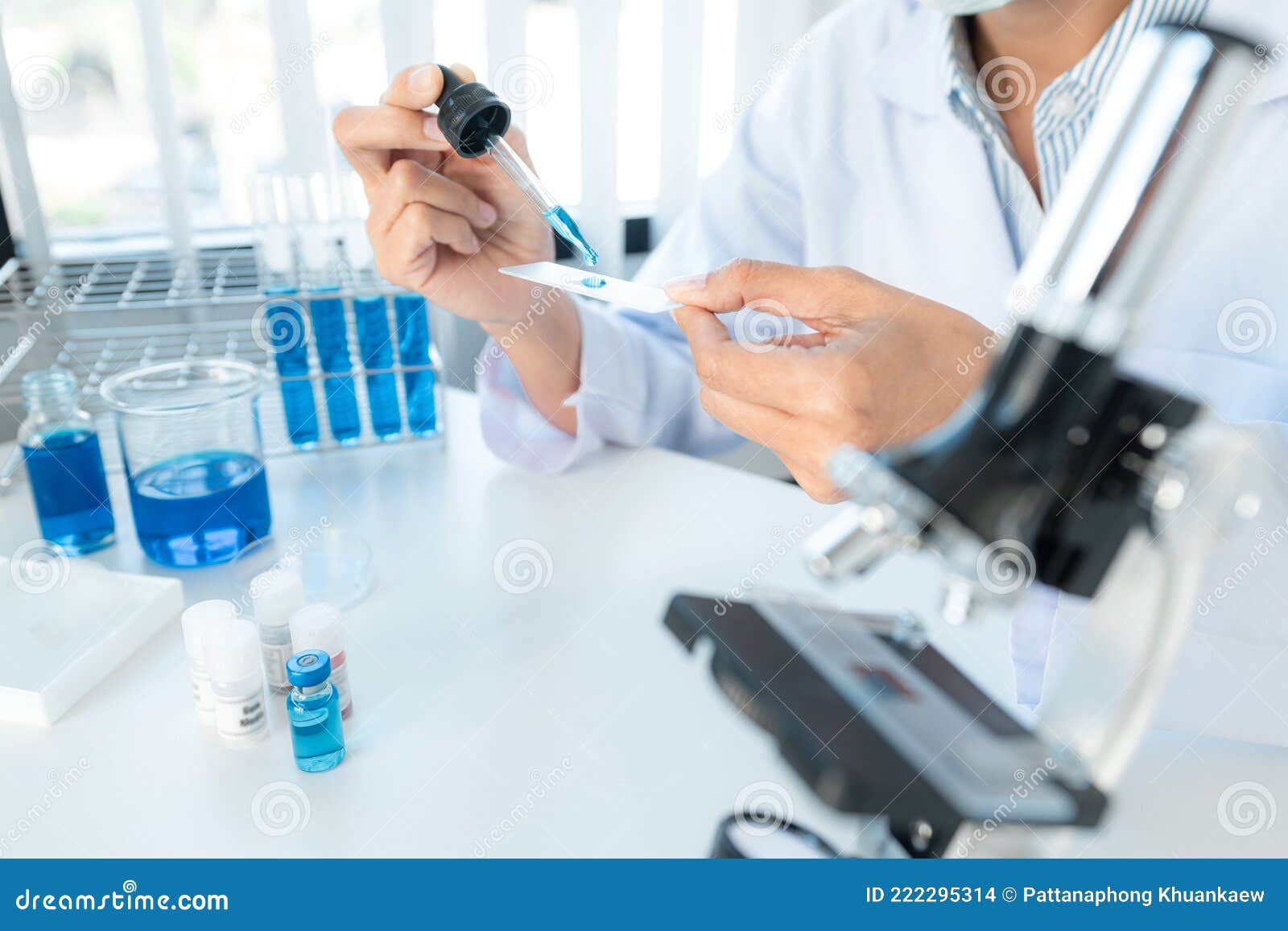 Scientist Woman Holding Dropper To Dropping Solution Sample on the ...