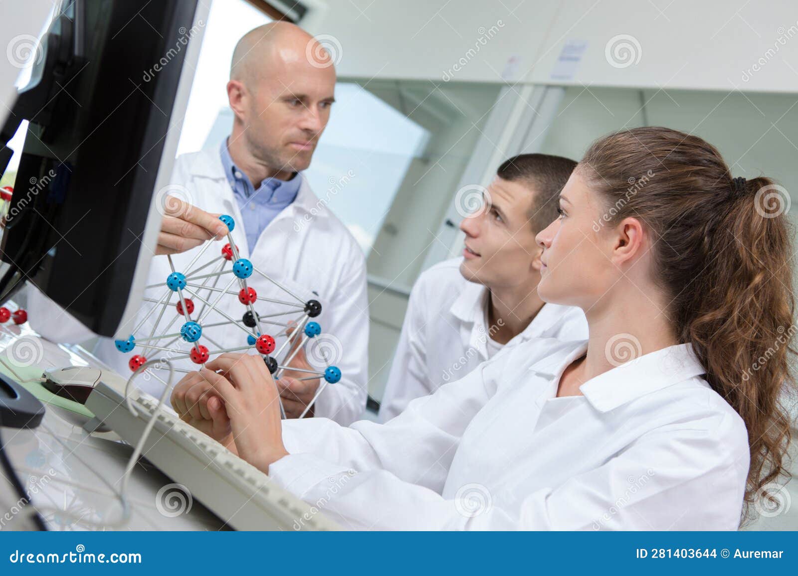 Scientist Working Attentively with Laptop and Dna Model in Laboratory ...
