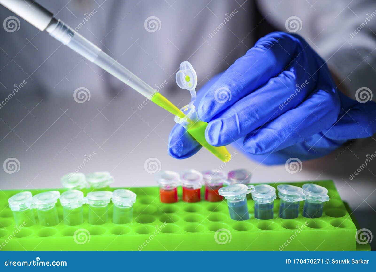 Scientist Working with Green Solution in Eppendorf Tube and Pipette for ...