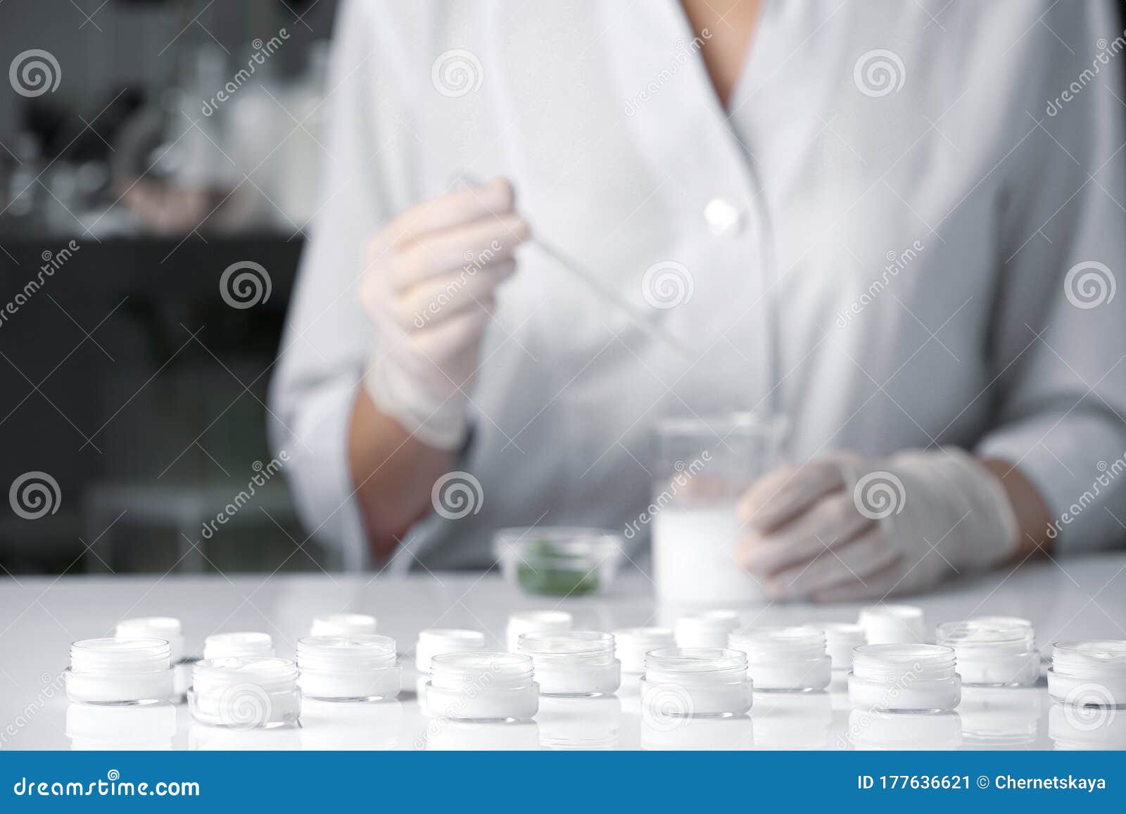 Scientist Working in Laboratory, Focus on Jars with Cosmetic Products ...