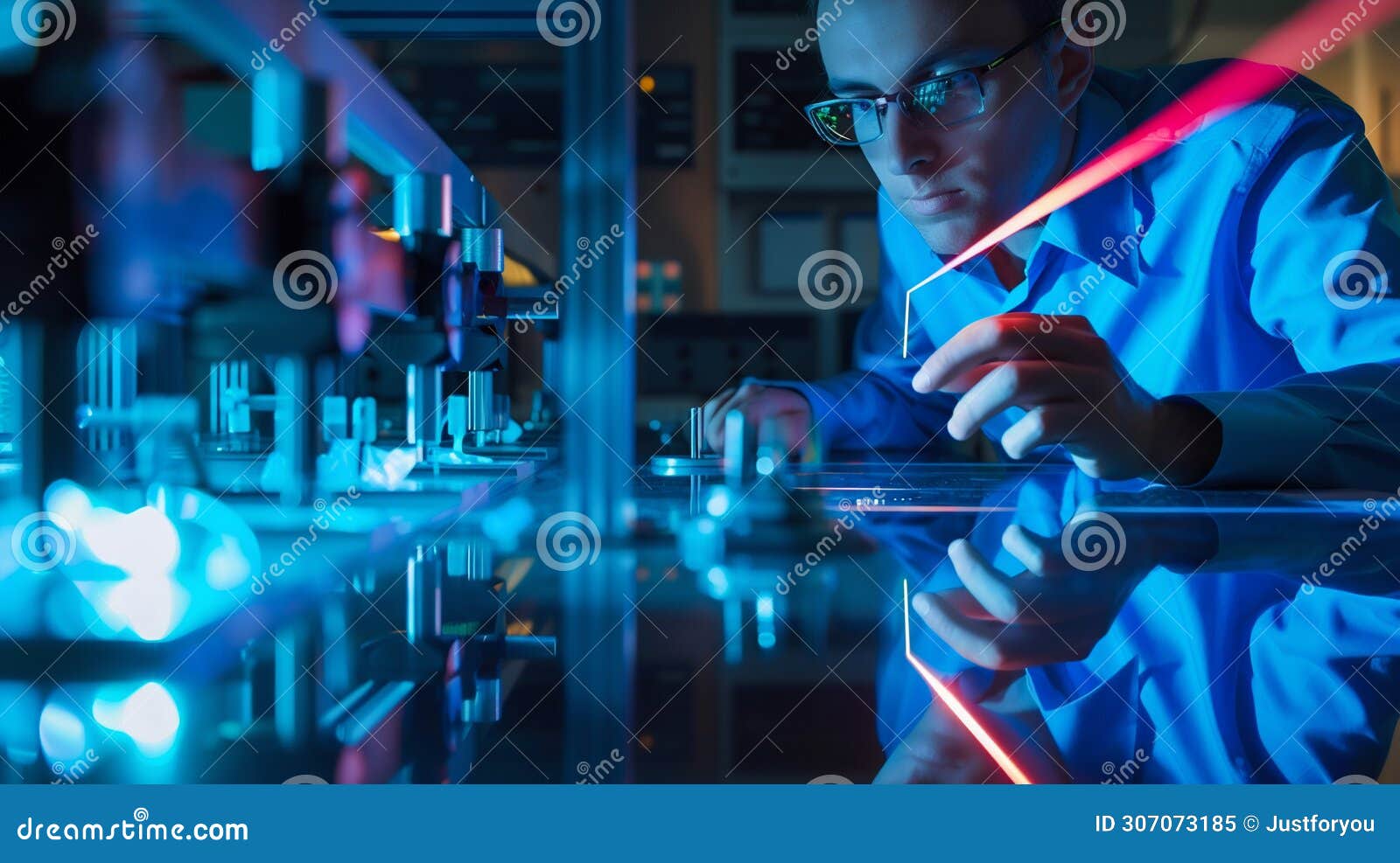 Scientist Working with Laser Technology in Modern Laboratory ...