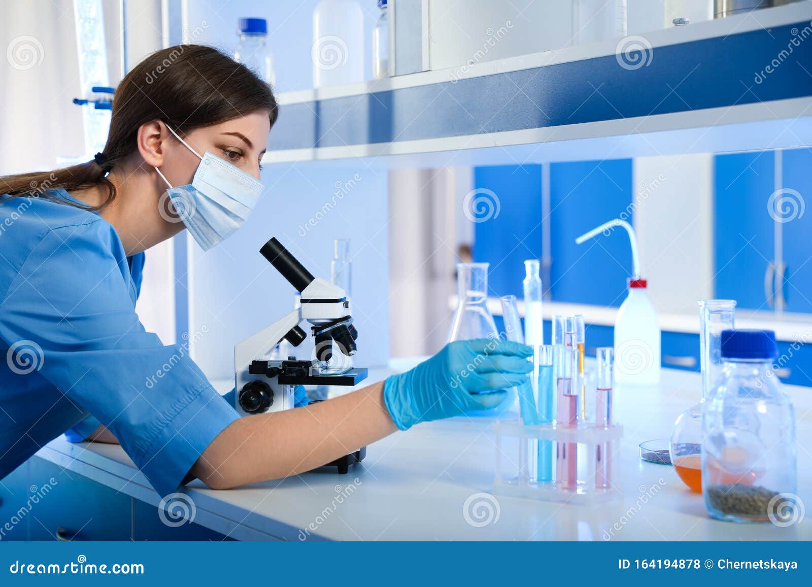 Scientist Working with Microscope and Test Tubes. Laboratory Analysis ...