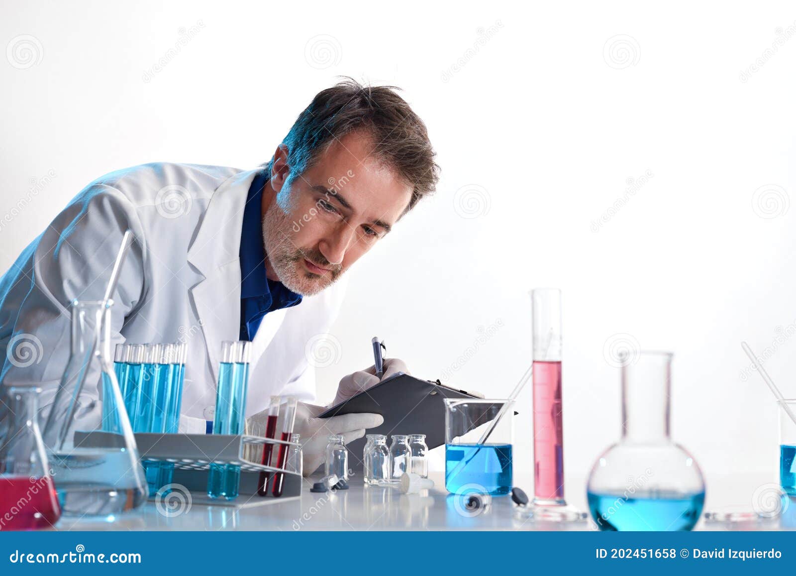 Scientist Writing in a Notebook on a Laboratory Table Isolated Stock ...
