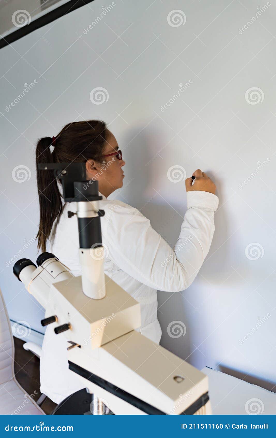 Scientist writing formulas stock photo. Image of light - 211511160