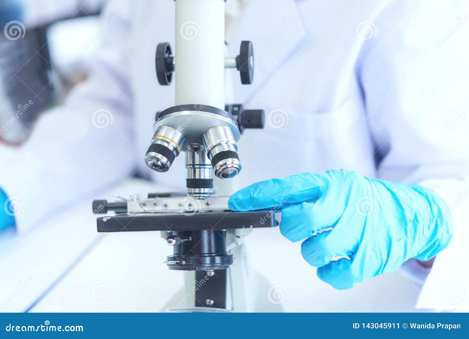 Scientists Analyzing Study Data and Evaluating Microscope. Health Care ...