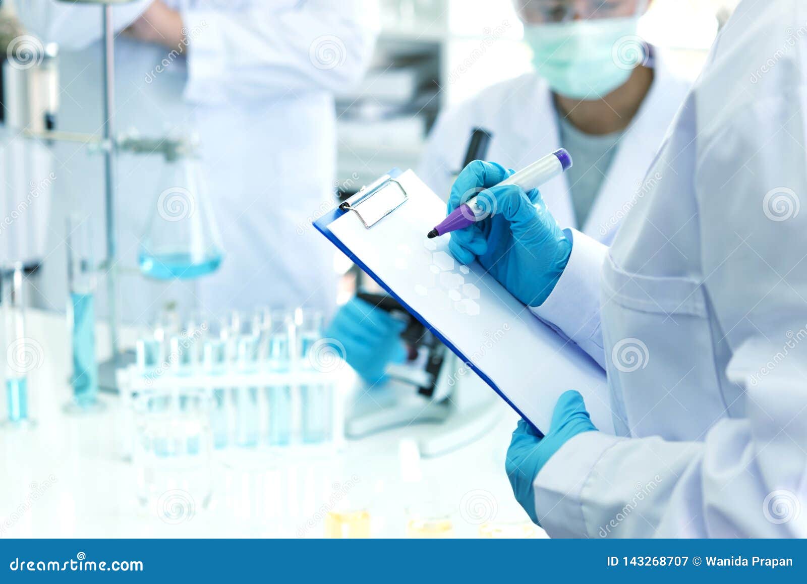 Scientists Analyzing Study Data And Evaluating Microscope. Health Care ...