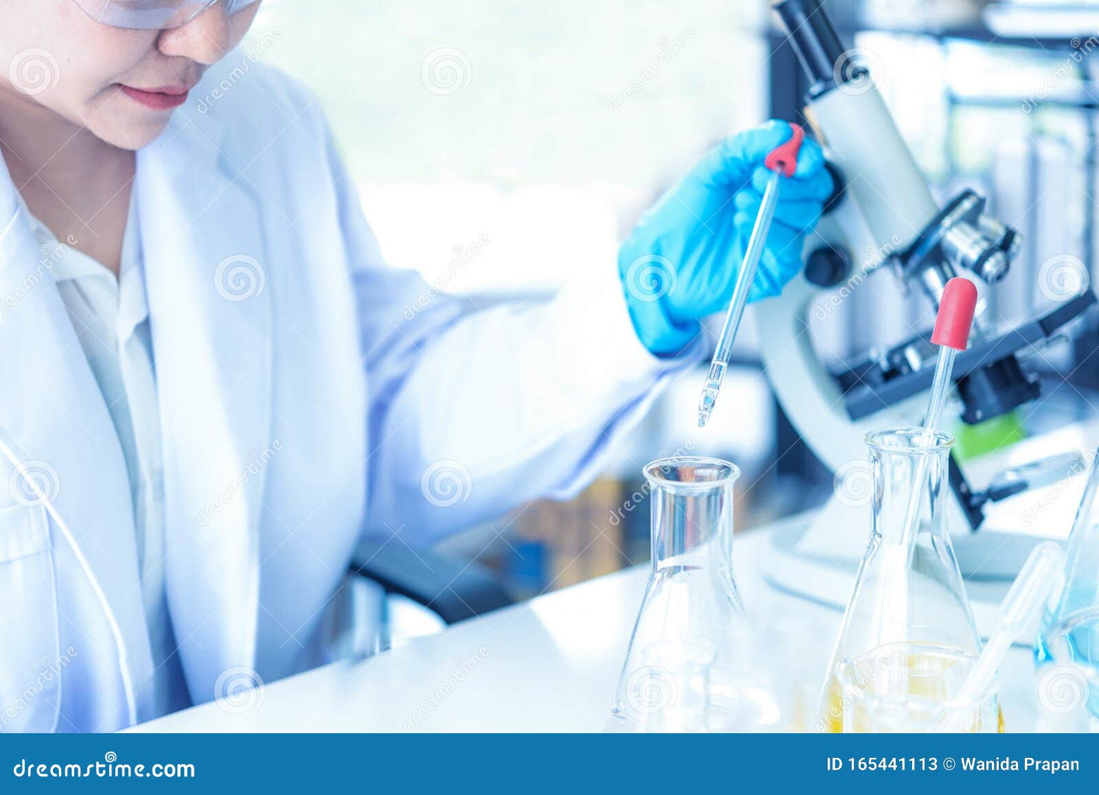 Scientists Analyzing Study Data and Evaluating Microscope. Health Care ...