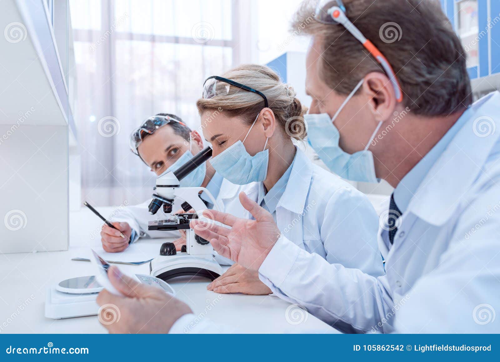 Scientists Doing Microscope Analysis Stock Photo - Image of handsome ...