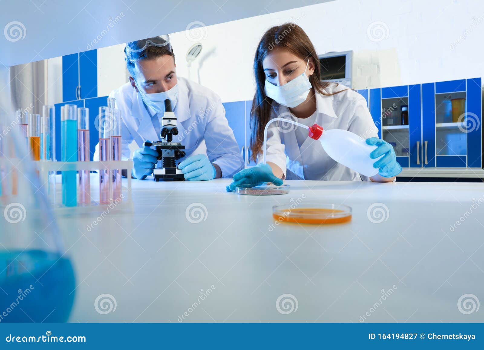 Scientists Doing Research and Analysis with Microscope Stock Image ...