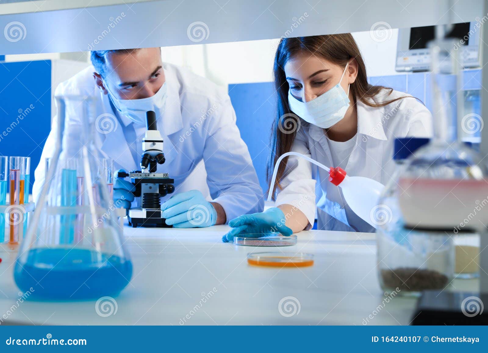 Scientists Doing Research and Analysis with Microscope Stock Image ...