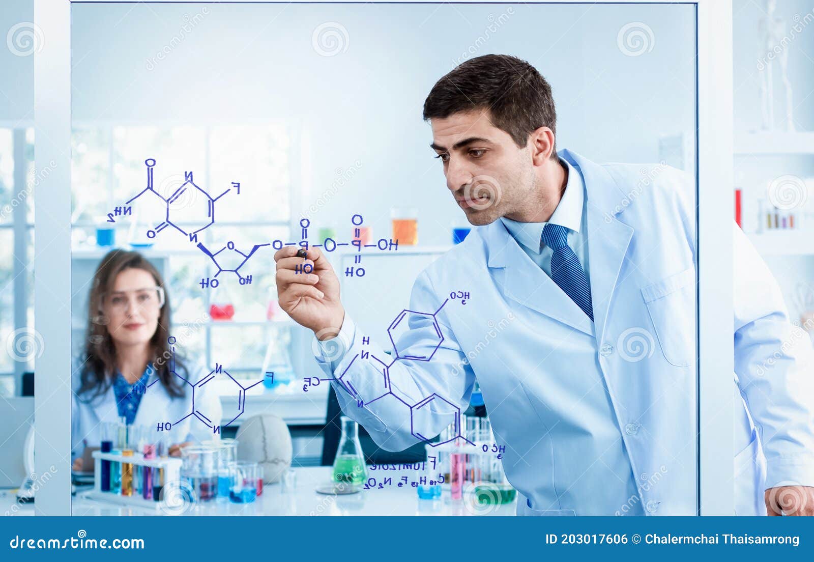 Scientists Drawing Chemical Formulas on Clear Board in Science ...