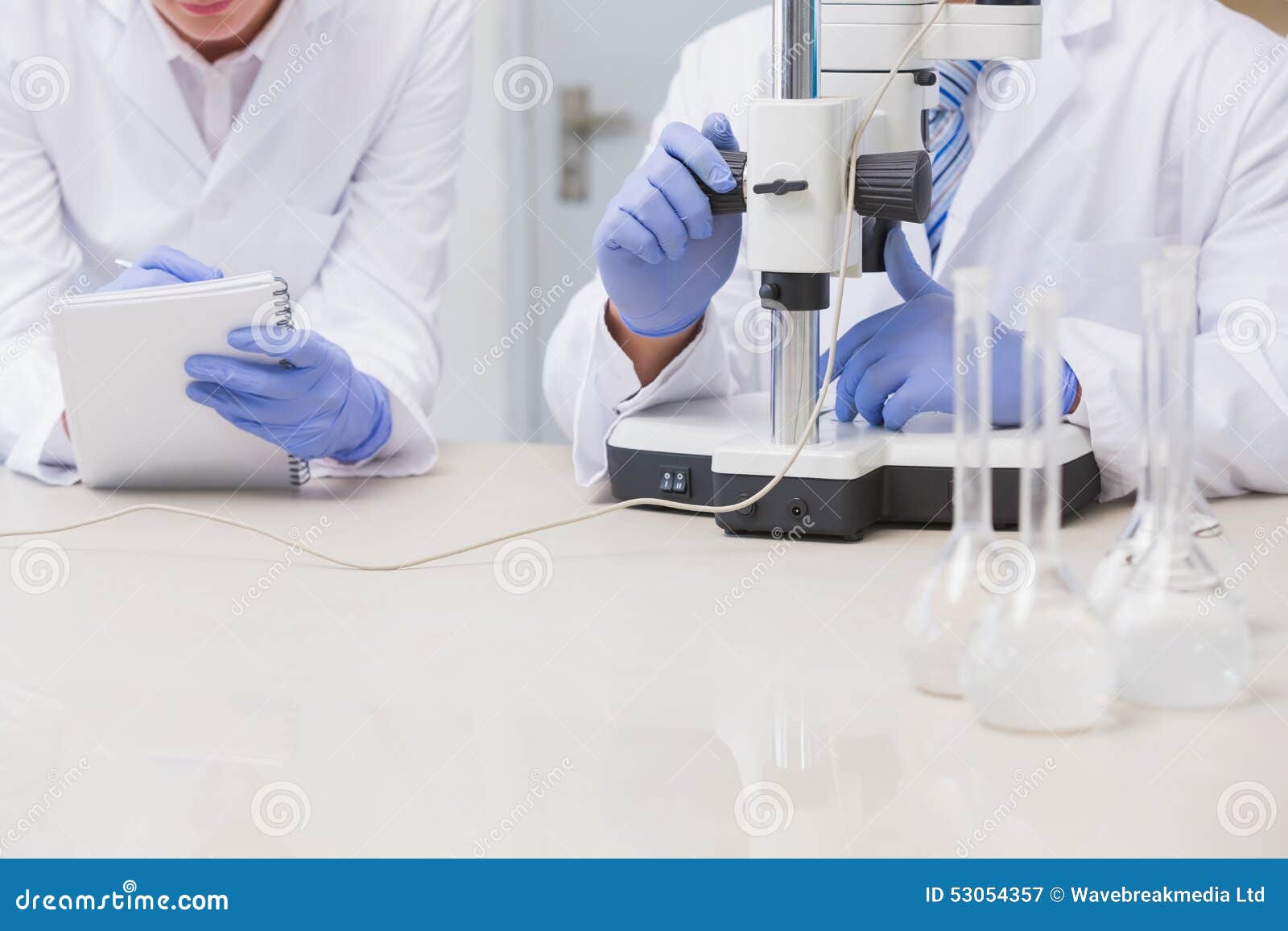 Scientists Examining Something with the Microscope Stock Image - Image ...