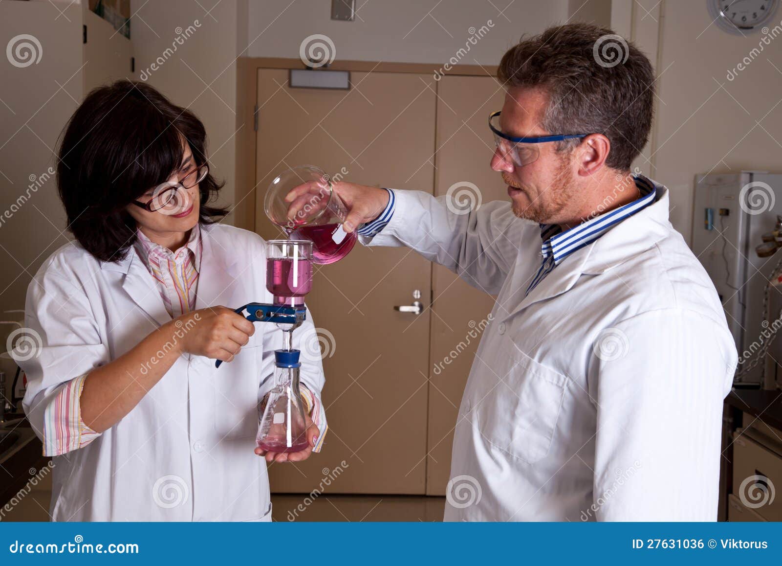 Scientists holding labware stock photo. Image of male - 27631036