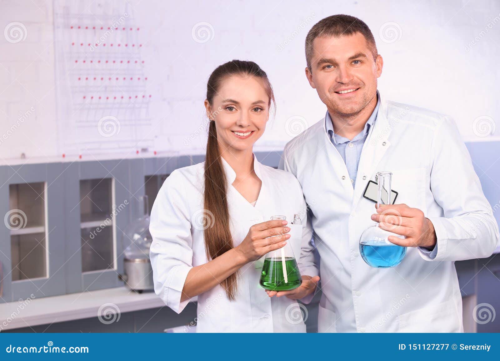 Scientists Holding Test Flasks with Samples in Laboratory Stock Image ...