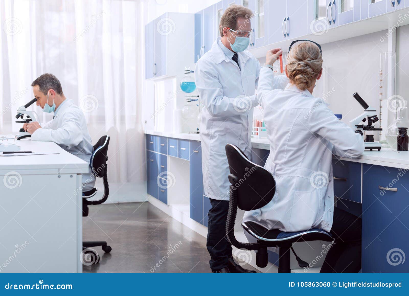 Scientists Working in Laboratory Stock Photo - Image of microscopes ...