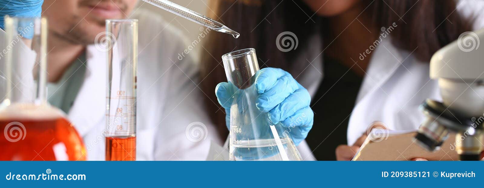 Scientists in Laboratory Hold Flask and Drip Clear Liquid into it ...