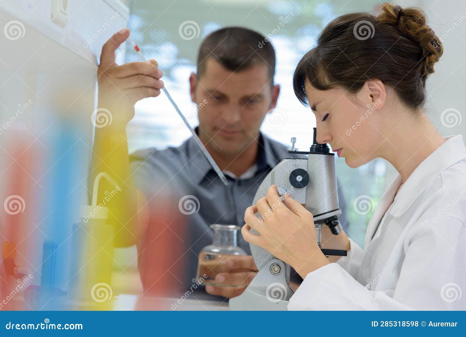 Scientists in Laboratory Using Microscope and Pipette Stock Photo ...