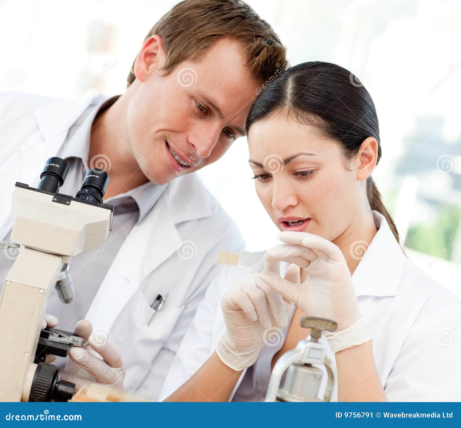 Scientists Looking at a Slide Under a Microscope Stock Image - Image of ...