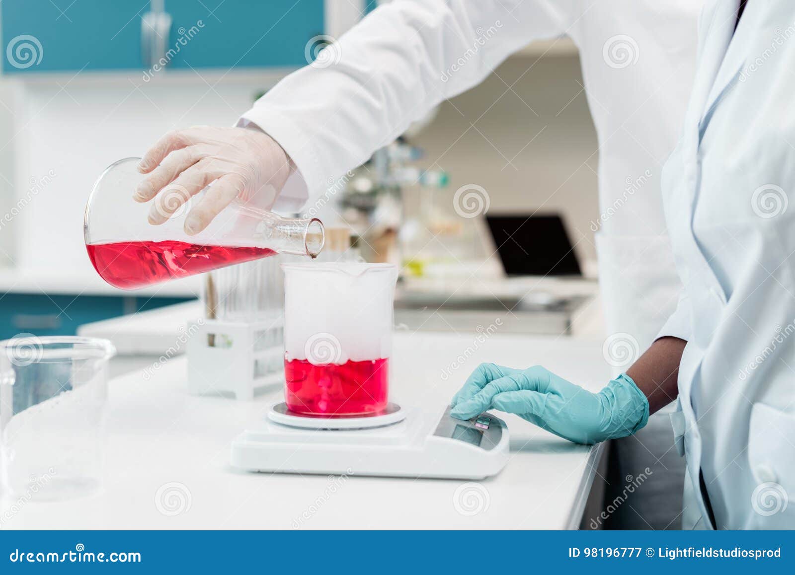 Scientists Making Experiment with Reagent and Flasks Stock Image ...