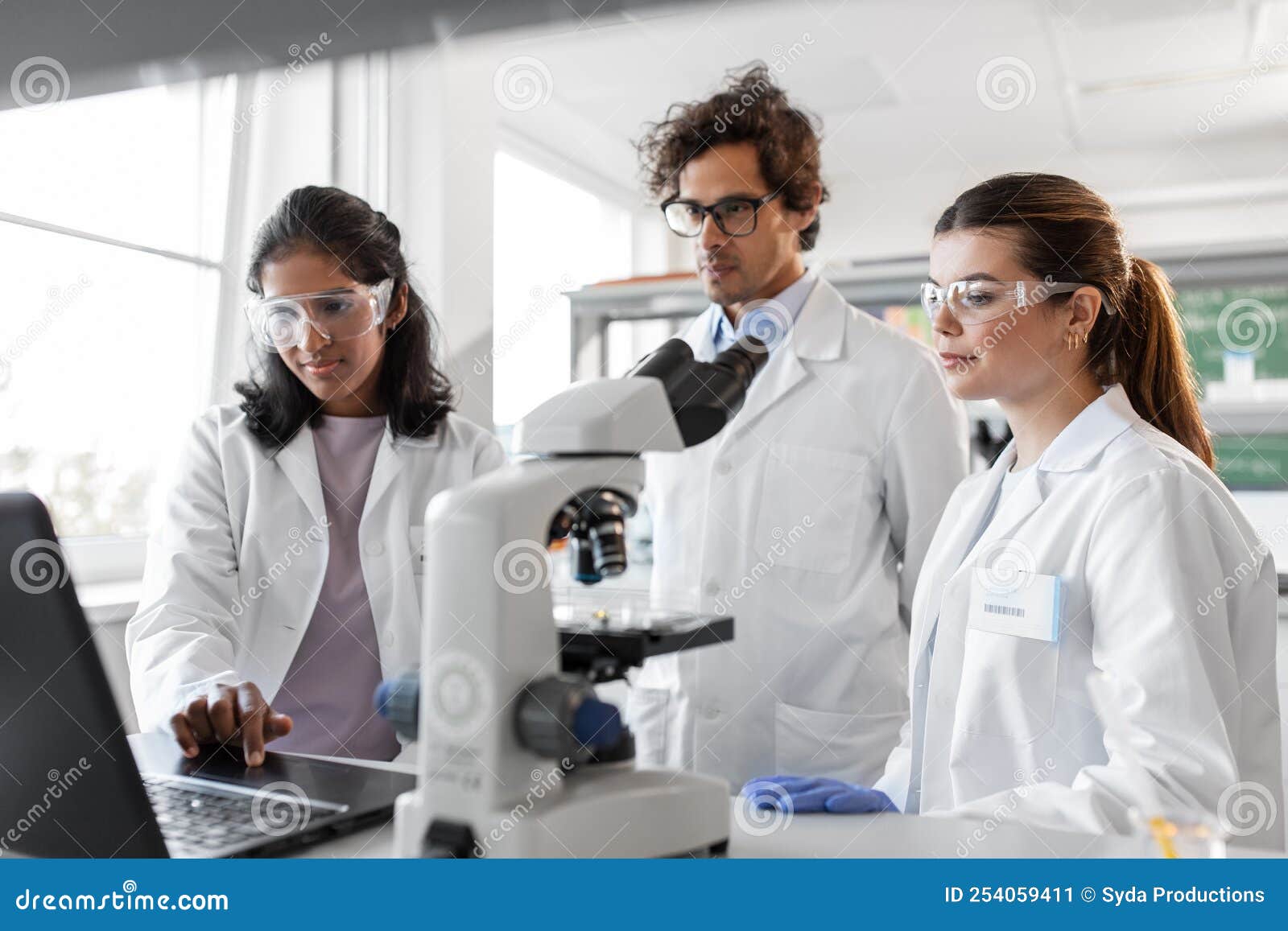 Scientists with Microscope Working in Laboratory Stock Image - Image of ...