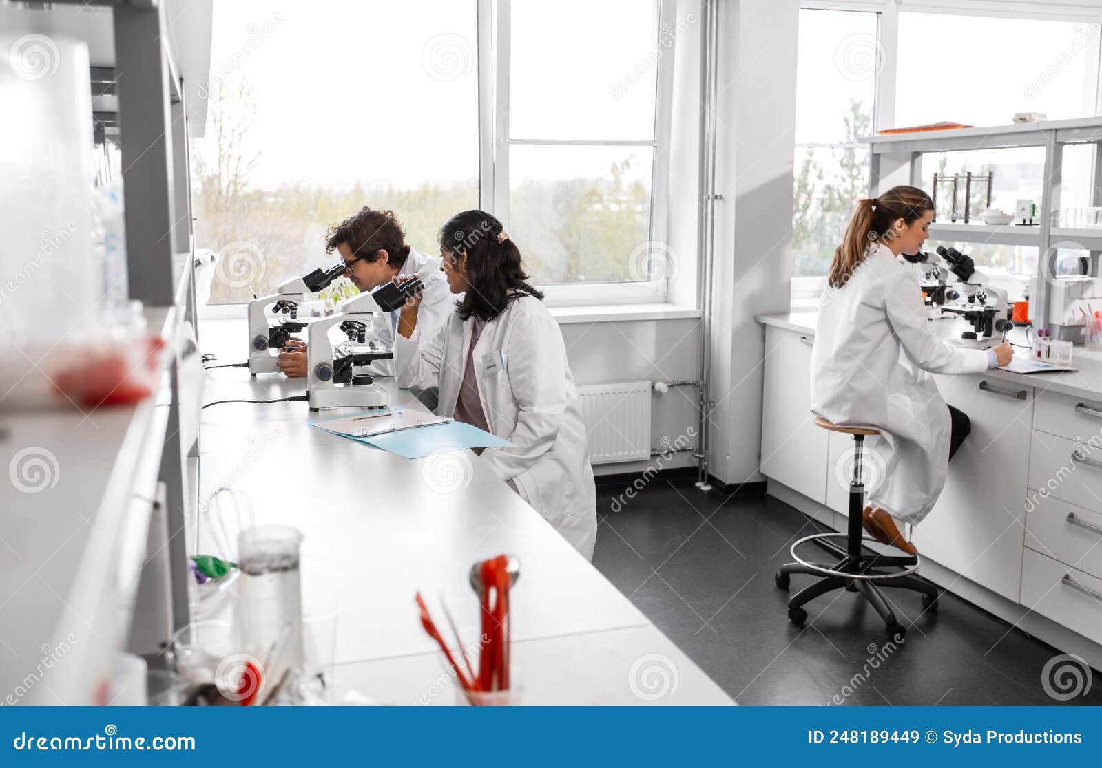 Scientists with Microscopes Working in Laboratory Stock Image - Image ...