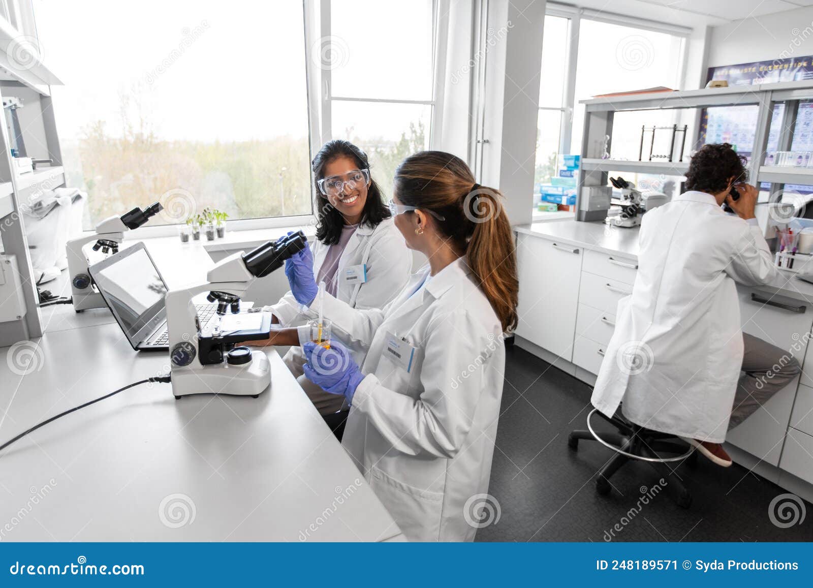 Scientists with Microscopes Working in Laboratory Stock Image - Image ...