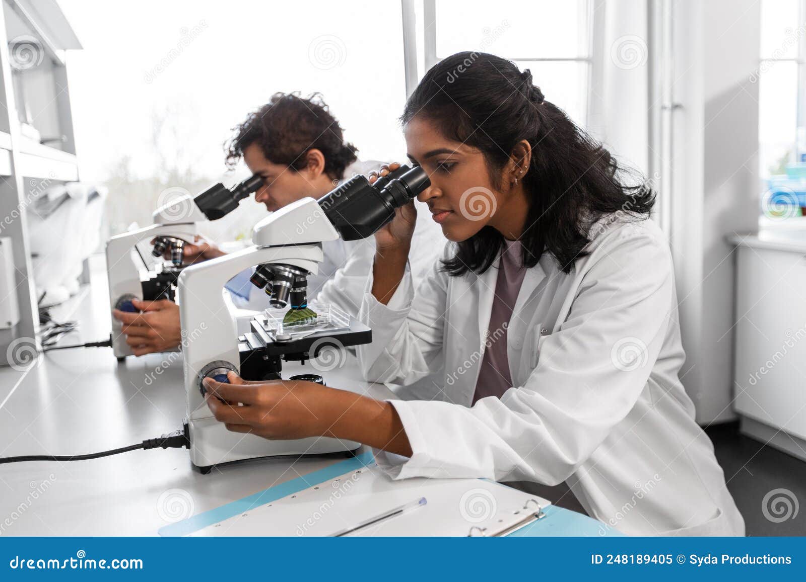 Scientists with Microscopes Working in Laboratory Stock Image - Image ...