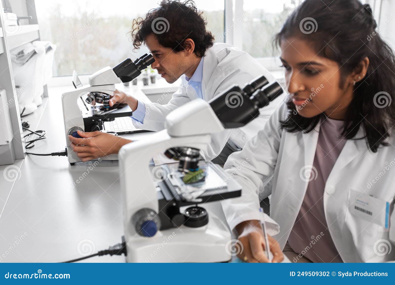 Scientists with Microscopes Working in Laboratory Stock Photo - Image ...
