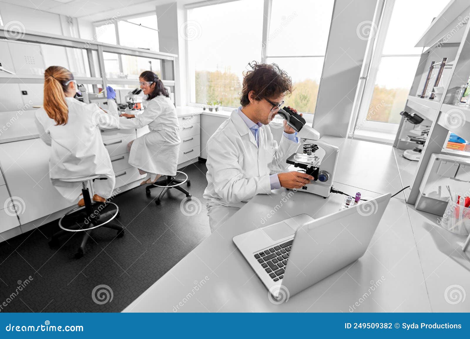 Scientists with Microscopes Working in Laboratory Stock Photo - Image ...