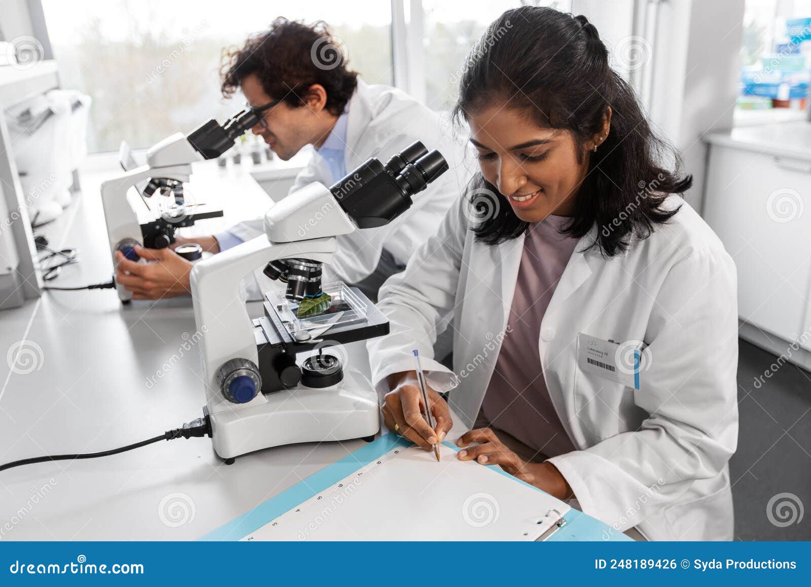 Scientists with Microscopes Working in Laboratory Stock Photo - Image ...