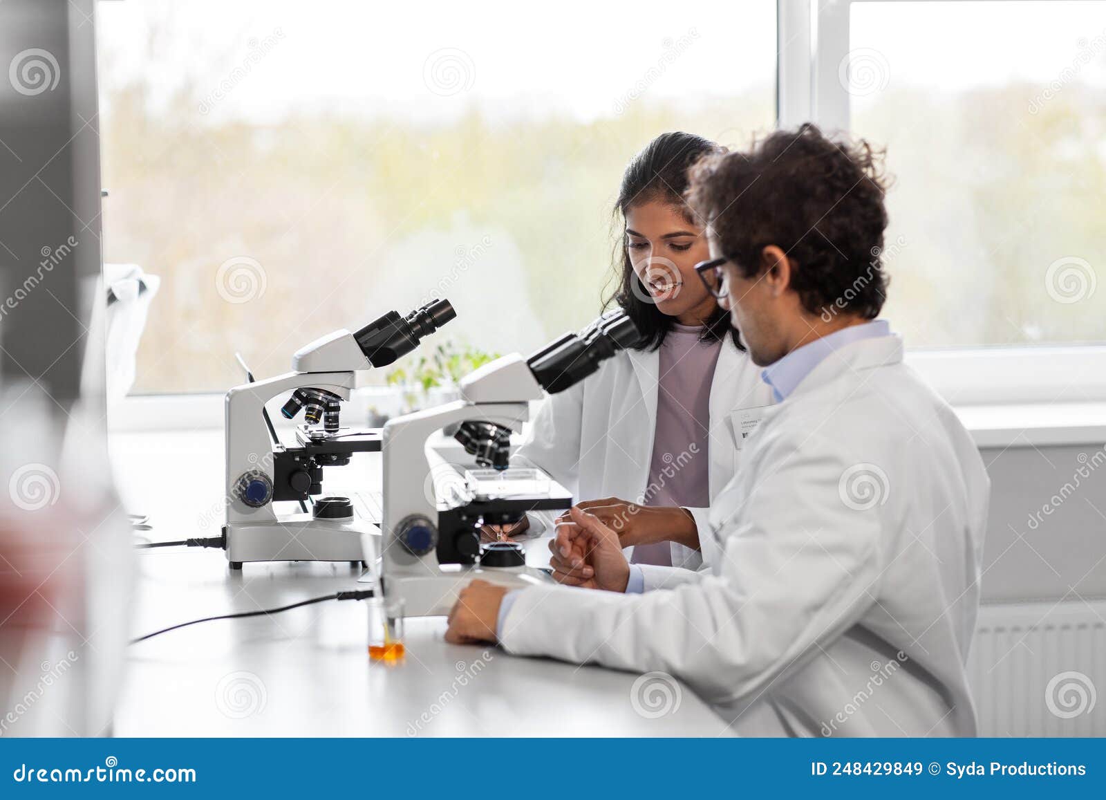 Scientists with Microscopes Working in Laboratory Stock Image - Image ...