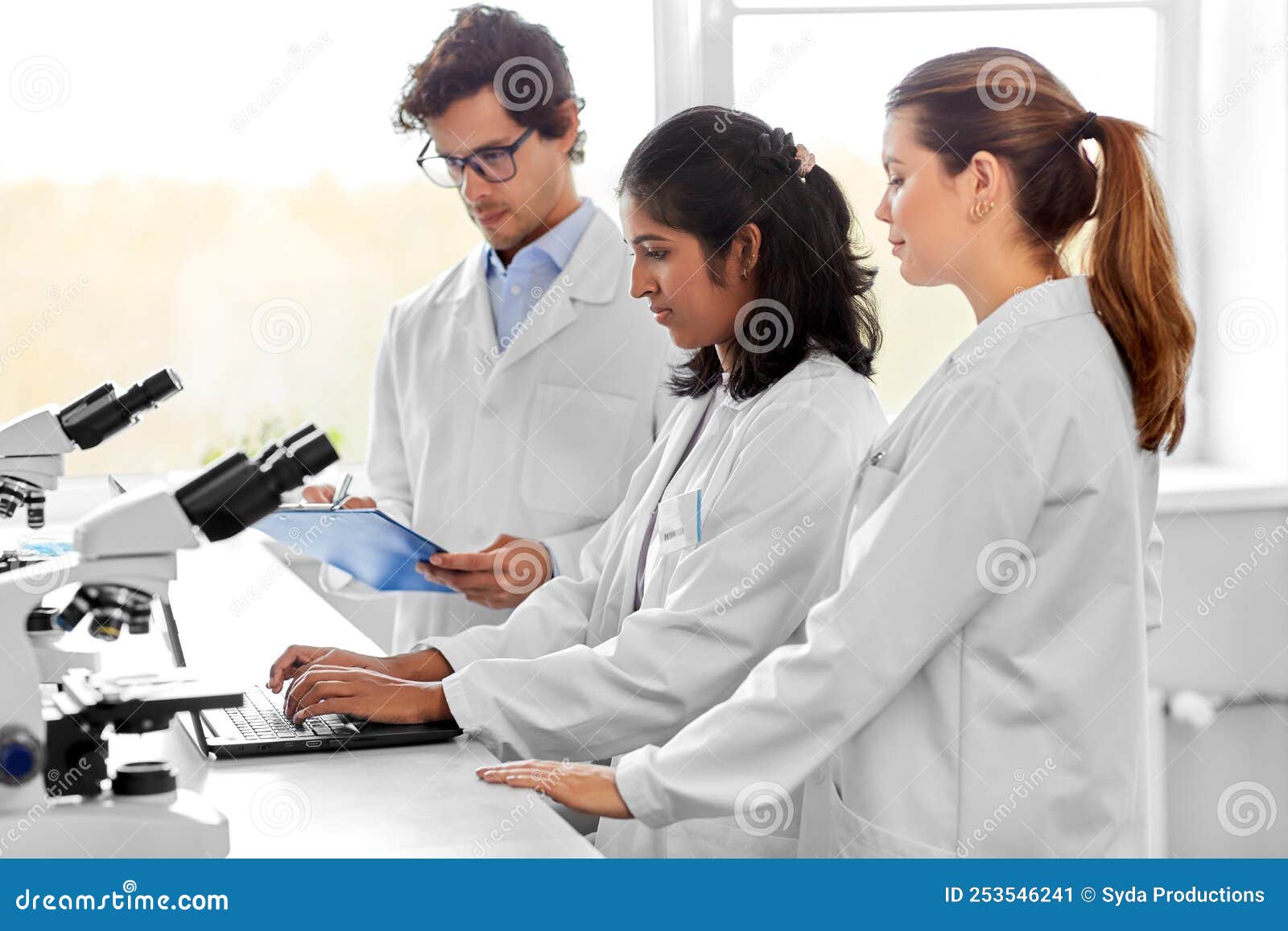 Scientists with Microscopes Working in Laboratory Stock Image - Image ...
