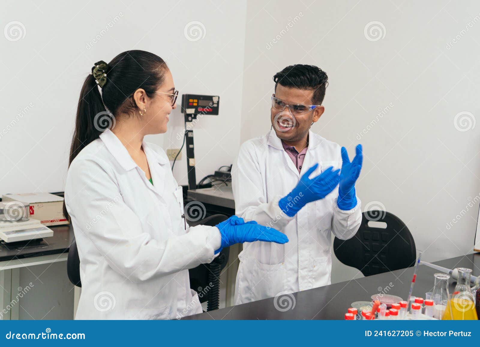 Scientists Preparing for Laboratory Work. Lab Technicians Putting on ...