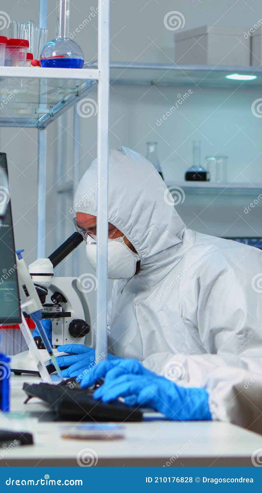 Scientists In Protection Suits And Masks Working In Research Lab Using ...
