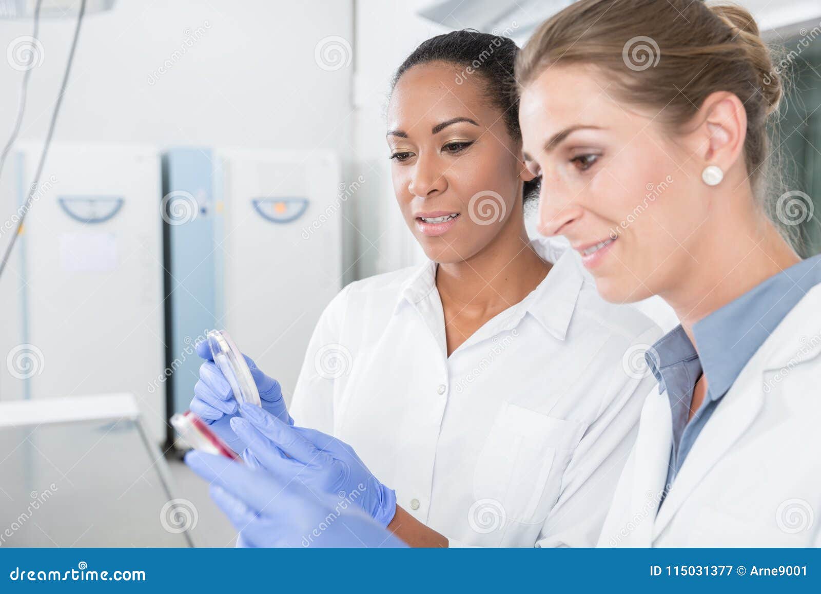 Scientists in Research Lab with Analyzing Instrument Talking about ...