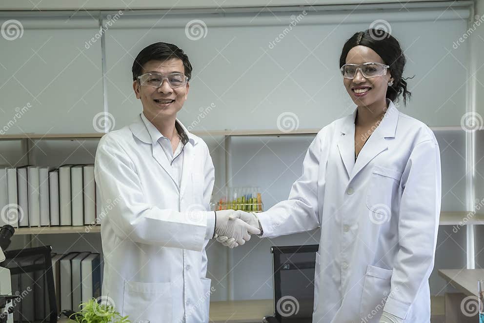 Scientists Shake Hands To Do Scientific Experiments Stock Image - Image ...