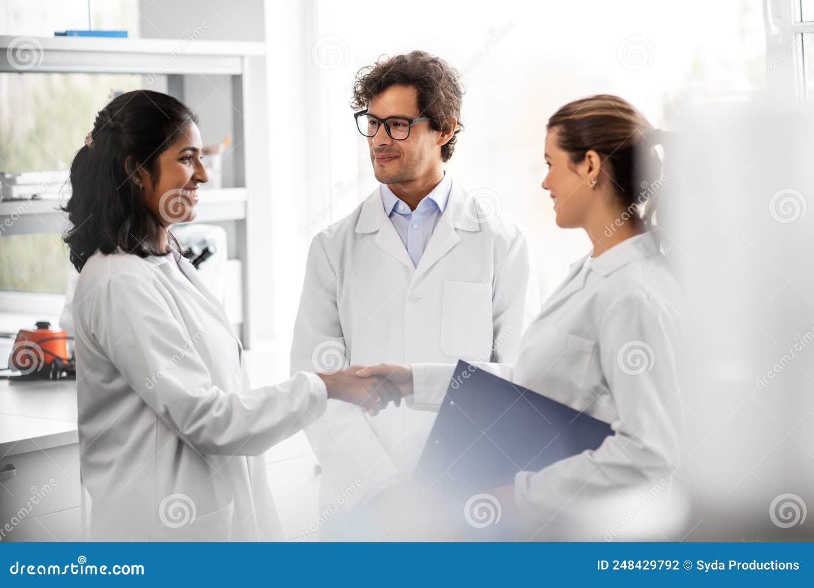 Scientists Shaking Hands in Laboratory Stock Photo - Image of shaking ...
