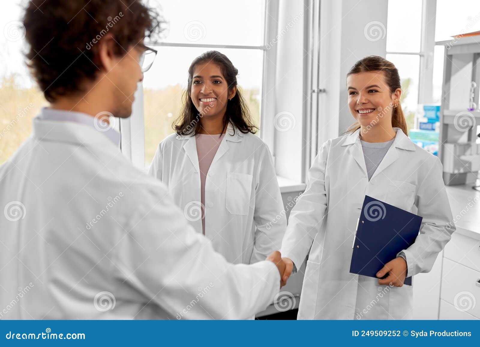 Scientists Shaking Hands in Laboratory Stock Photo - Image of greeting ...